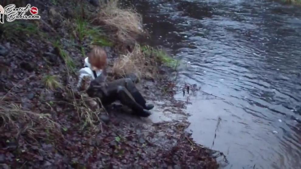 Russian Blonde In Muddy Chest Waders Enjoying Riverside Mud